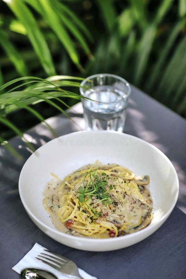 Pasta Bucatini Carbonara and Coconut on the Table. Stock Image - Image ...