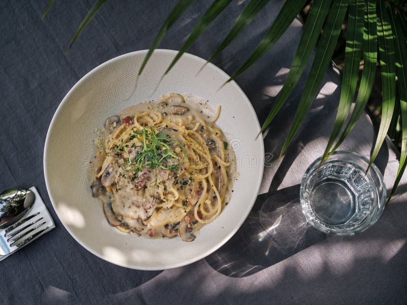 Pasta Bucatini Carbonara and Coconut on the Table. Stock Image - Image ...