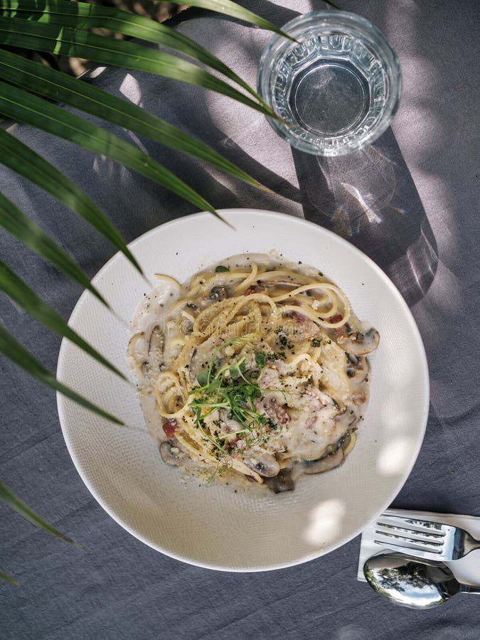 Pasta Bucatini Carbonara and Coconut on the Table. Stock Image - Image ...