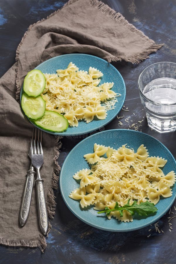 Pasta with Cheese . Macaroni are Served in a Blue Plate on a Dark Blue ...