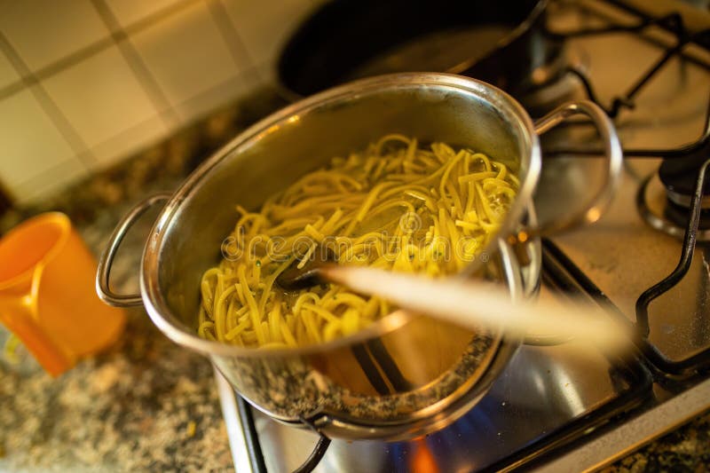 Pasta Cooking on Stove stock photo. Image of steam, utensils - 315271976