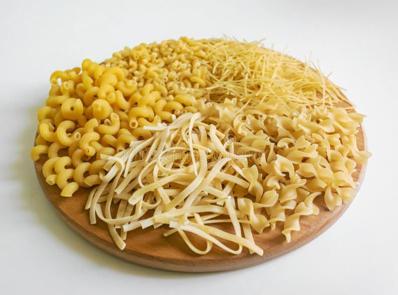 Pasta of Different Types on a Round Wooden Stand on a White Background ...