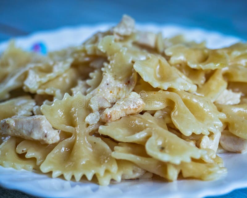 Pasta in the Form of Bows with Cheese on a Light Plate Stock Photo ...