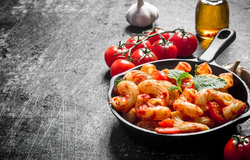Pasta in Pan with Garlic, Tomatoes and Mint Leaves Stock Image - Image ...