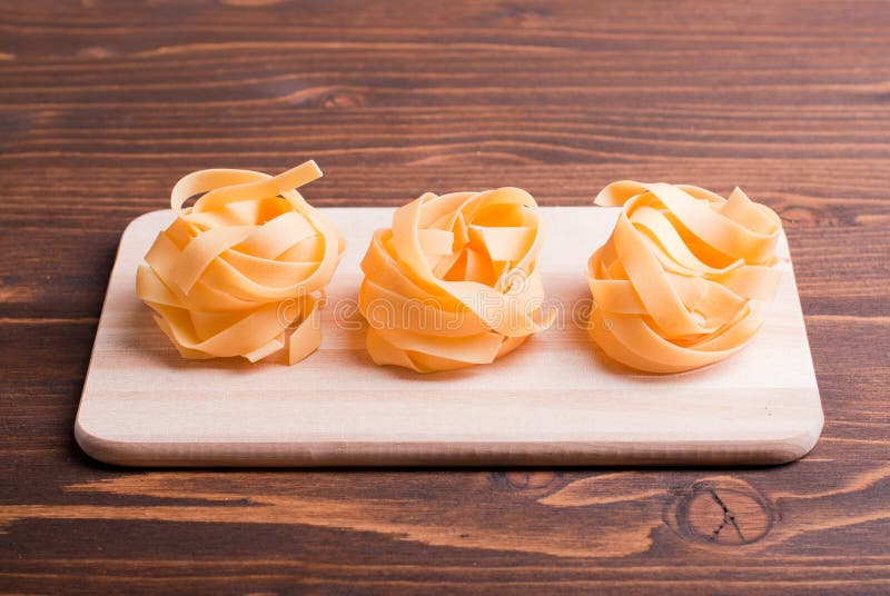 Pasta Raw Three Circles in a Row on a Small Cutting Board on a L Stock ...