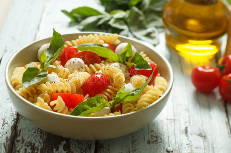 Pasta Salad with Cherry Tomatoes and Basil Leaves Stock Image - Image ...
