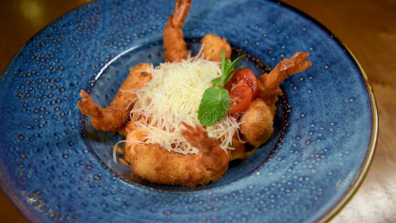 Pasta with Seafood in Breading with Cheese on a Blue Plate Stock ...