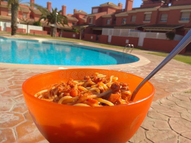 Pasta by the swimming pool stock photo. Image of views - 110626578