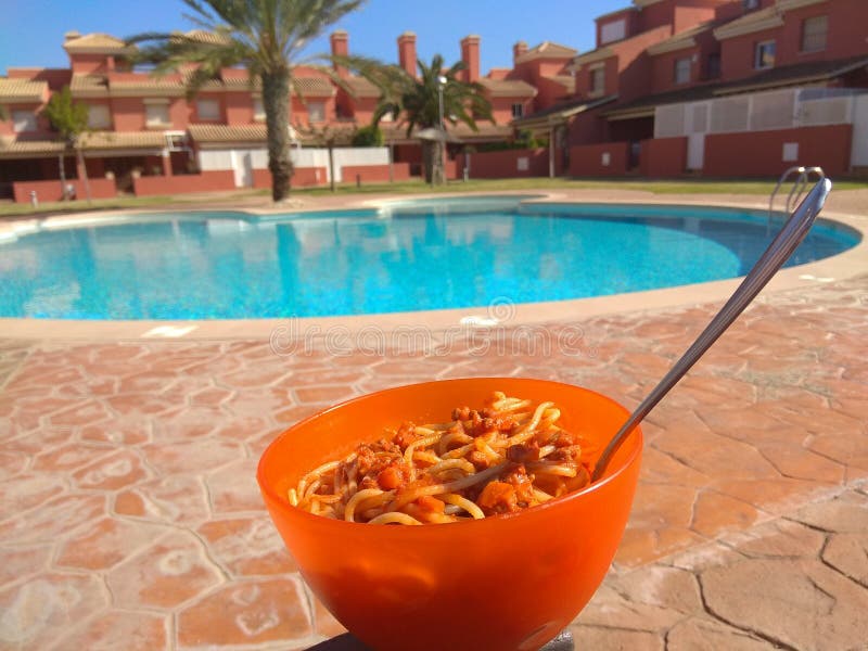 Pasta by the swimming pool stock photo. Image of views - 110626828