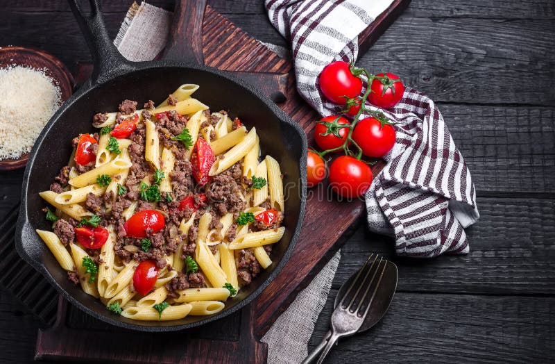 Pasta with Tomatoes and Meat on Dark Rustic Background. Stock Image ...