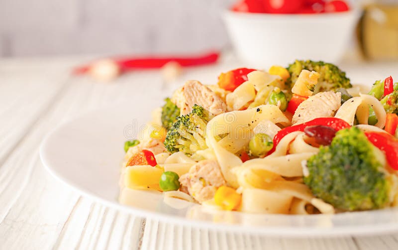 Pasta with Vegetables on a Plate Against a Brick Wall Background Stock ...