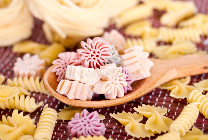 Pasta in a wooden spoon stock image. Image of ingredients - 59953471