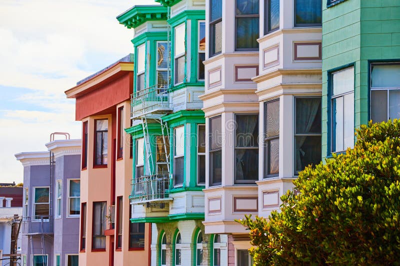 Pastel Colored Apartment Buildings with Wide Array of Bay Windows Side ...