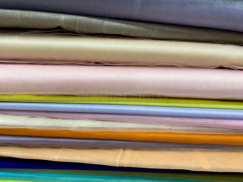 Pastel Layers of Fabric Rolls Displayed in a Neat Stack, Ideal for ...