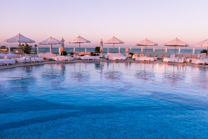 Pastel Sunset Light Over Swimming Pool and Sun Beds Stock Photo - Image ...