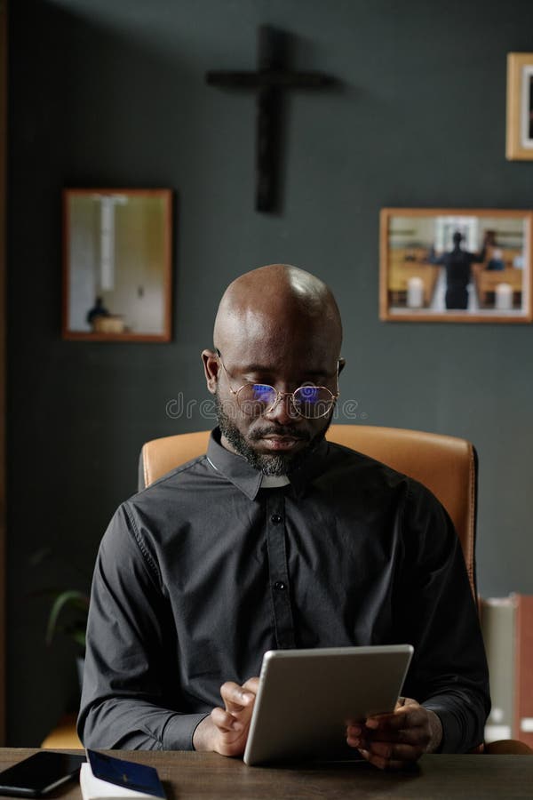 Pastor with Tablet in Hands Sitting in Office Stock Photo - Image of ...