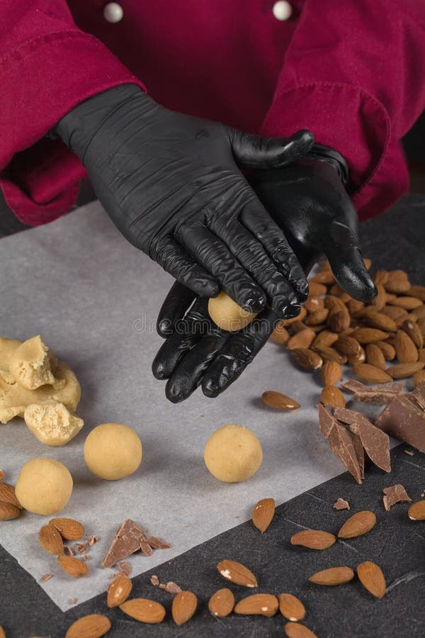 The Pastry Chef in Black Gloves Shapes the Candy Dough Stock Image ...