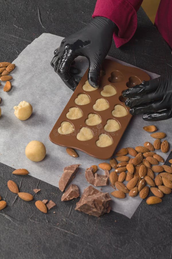 The Pastry Chef in Black Gloves Shapes the Candy Dough. Stock Image ...