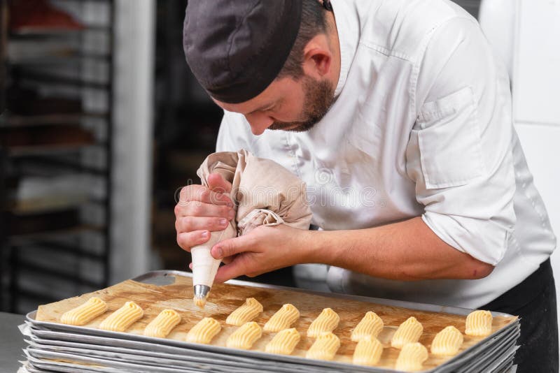 Pastry Chef with Confectionary Bag Squeezing Cream at Pastry Shop ...