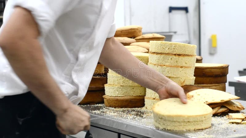 Pastry Chef Cutting the Sponge Cake on Layers. Cake Production Process ...