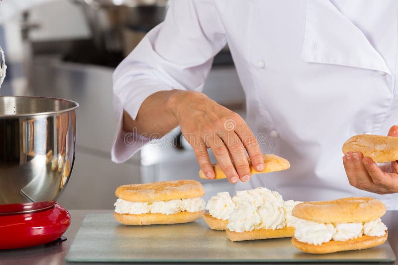 Pastry chef decorating stock photo. Image of ladyfingers - 74731518
