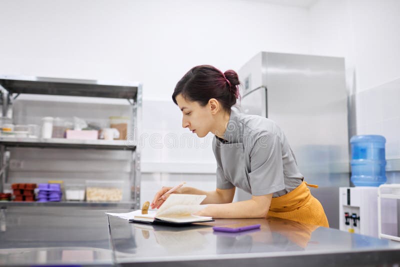 The Pastry Chef Girl Makes Notes in a Notebook Stock Image - Image of ...