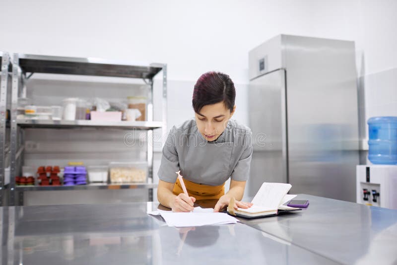 The Pastry Chef Girl Makes Notes in a Notebook Stock Photo - Image of ...