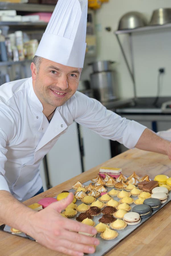 Pastry Chef Holding Delicious Looking Cakes and Pastries Stock Photo ...