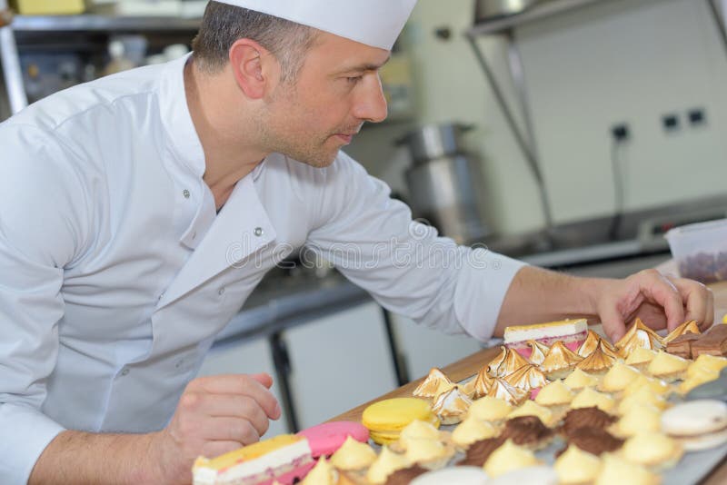 Pastry Chef Holding Delicious Looking Cakes and Pastries Stock Image ...
