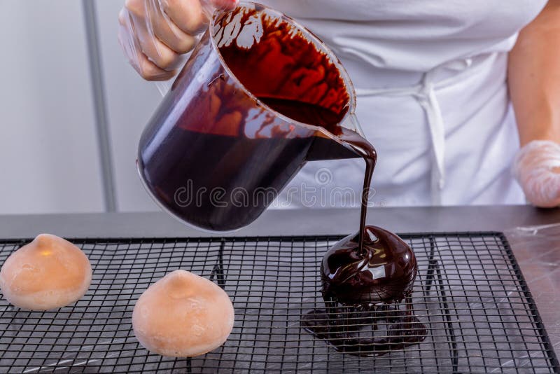 The Pastry Chef in the Kitchen Glazes Pastries. Cook Pours Chocolate ...