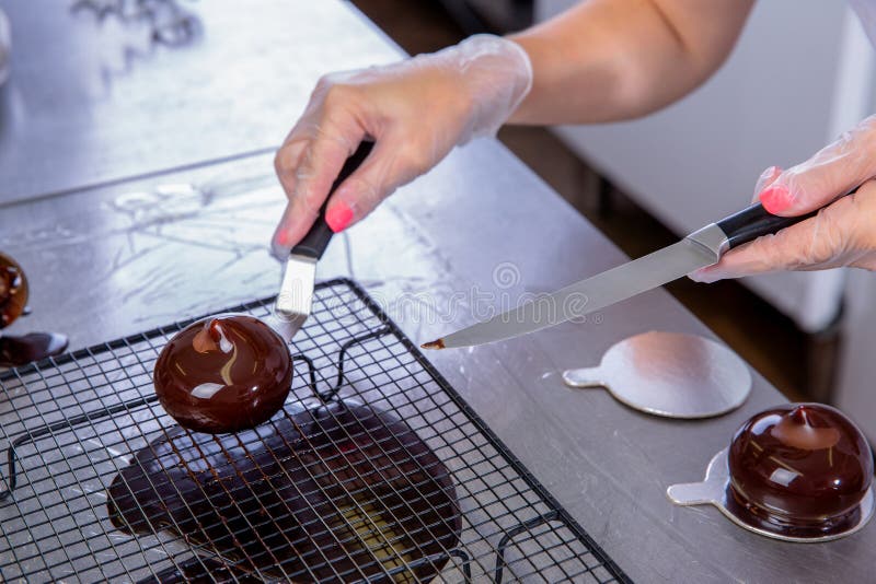 The Pastry Chef in the Kitchen Glazes Pastries. Cook Puts Glazed Cakes ...