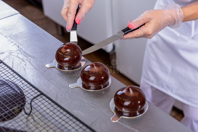 The Pastry Chef in the Kitchen Glazes Pastries. Cook Puts Glazed Cakes ...