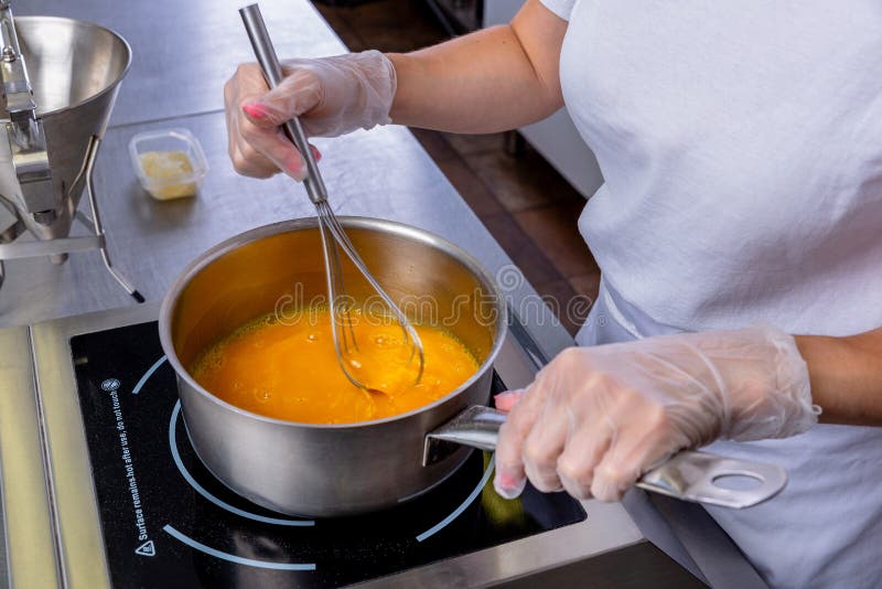 Pastry Chef in the Kitchen Makes Passion Fruit Confit. Cook Mixes the ...