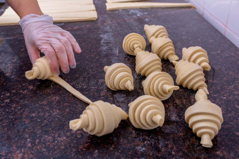 A Pastry Chef in the Kitchen is Making Pastries. the Chef Hands Rolls ...