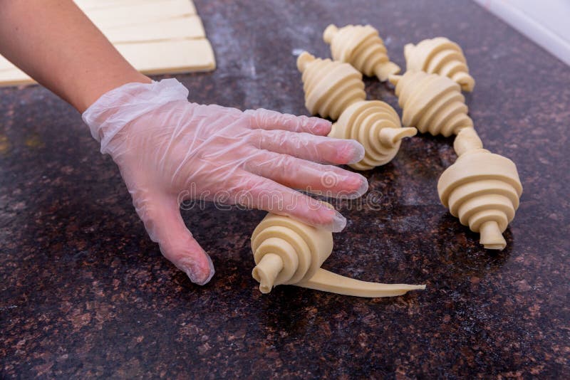 A Pastry Chef in the Kitchen is Making Pastries. Chef Rolls the Cut ...