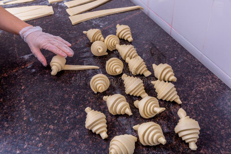 A Pastry Chef in the Kitchen is Making Pastries. Chef Rolls the Cut ...