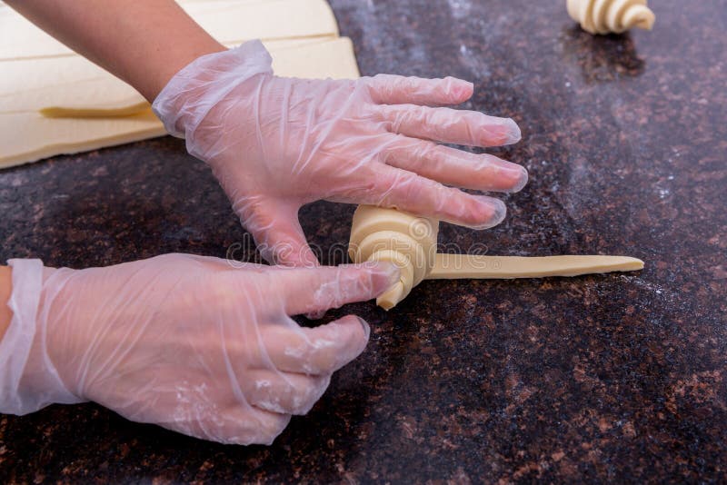 A Pastry Chef in the Kitchen is Making Pastries. Chef Rolls the Cut ...