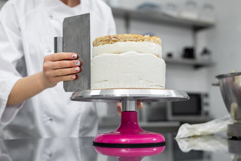 The Pastry Chef Levels the Cake with Cream. Stock Image - Image of cook ...