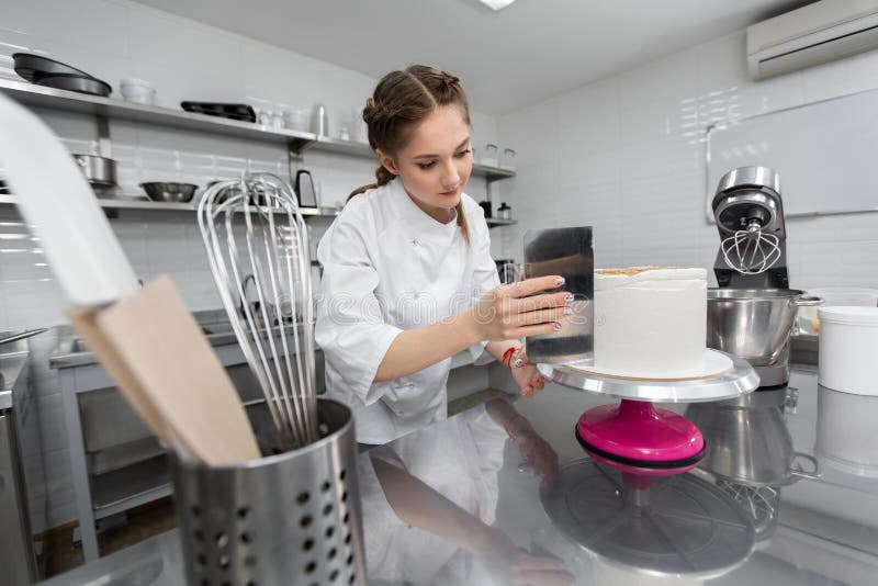 The Pastry Chef Levels the Cake with Cream. Stock Image - Image of food ...