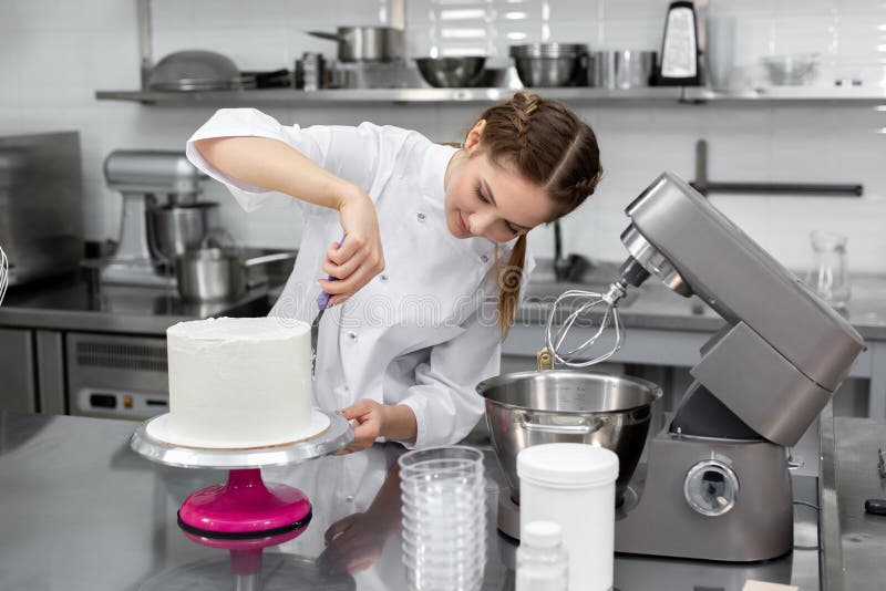 The Pastry Chef Levels the Cake with Cream. Stock Image - Image of ...