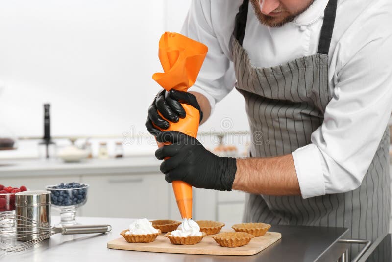 Pastry Chef Preparing Desserts at Table in Kitchen Stock Image - Image ...
