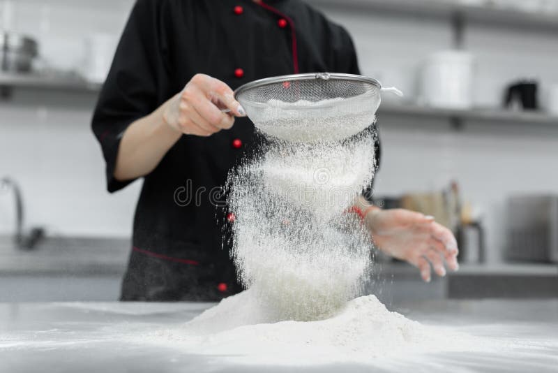 The Pastry Chef& X27;s Hands Sift the Flour through a Sieve on the ...