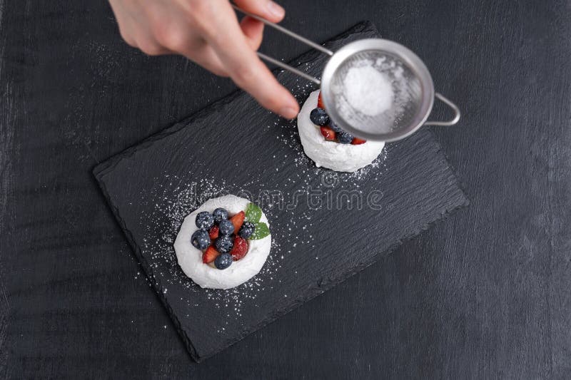 Pastry Chef Sprinkles Icing Sugar on the Berry Cakes. Process of Making ...