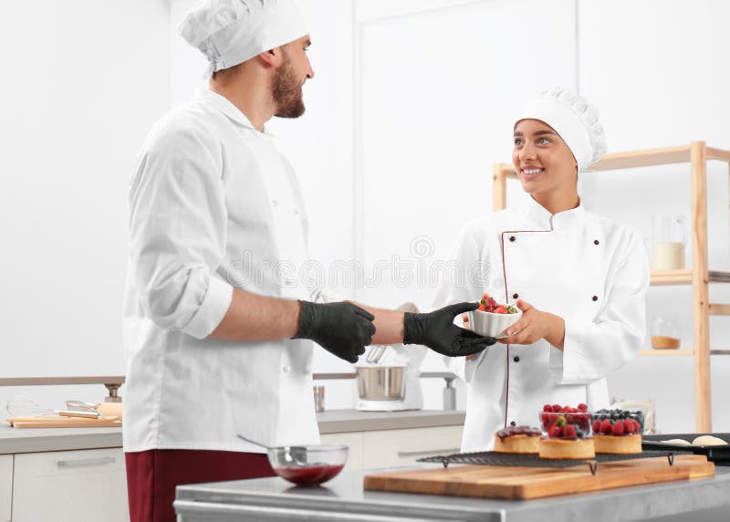 Pastry Chefs Preparing Desserts at Table Stock Image - Image of dessert ...