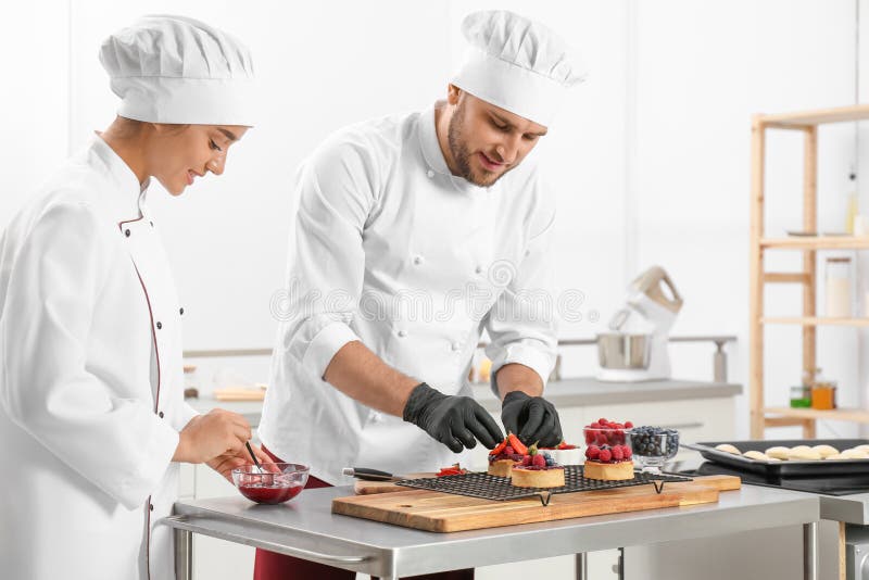 Pastry Chefs Preparing Desserts at Table Stock Image - Image of board ...