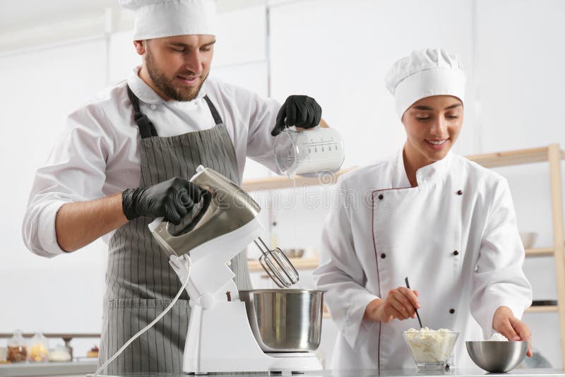 Pastry Chefs Preparing Dough in Mixer at Table Stock Image - Image of ...