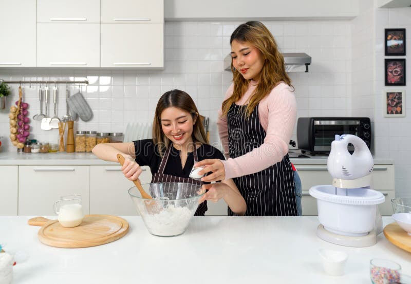 A Pastry Teacher Stands with Her Hand on Her Hip while Helping Her ...