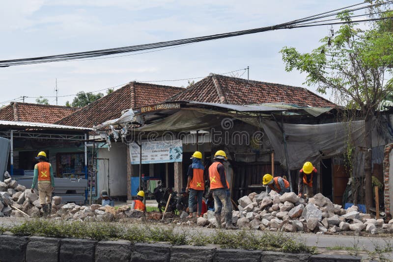 Workers are Digging the Old Drainage To Expand beside the Highway ...
