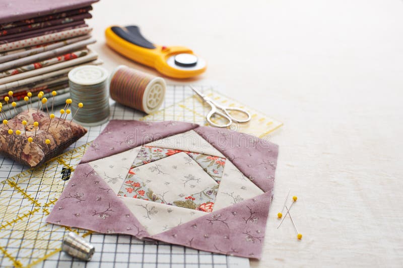 Patchwork Block on Craft Mat, Stack of Fabric, Sewing Accessories on ...