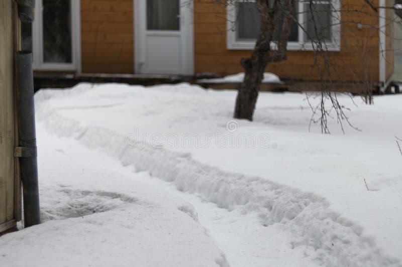 A Path Cleared of Snow Leads To an Old, Rickety Gate and Pillars Stock ...
